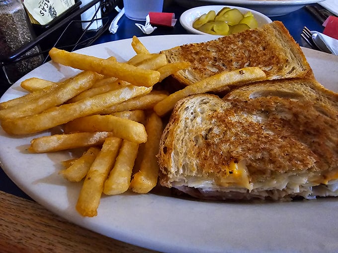The humble grilled cheese elevated to art form—golden, buttery, and oozing with melted goodness. Paired with those fries, it's childhood nostalgia with adult appeal.