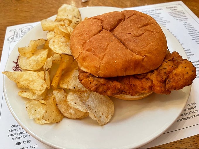 The Hometown Tenderloin – where the sandwich overachieves by hanging off the plate. Comfort food that demands two hands and zero pretension.