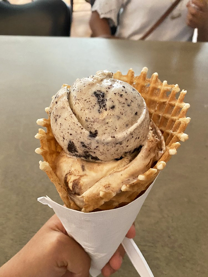 The waffle cone—architecture you can eat. This golden, crispy vessel cradles cookies and cream with the dignity it deserves.