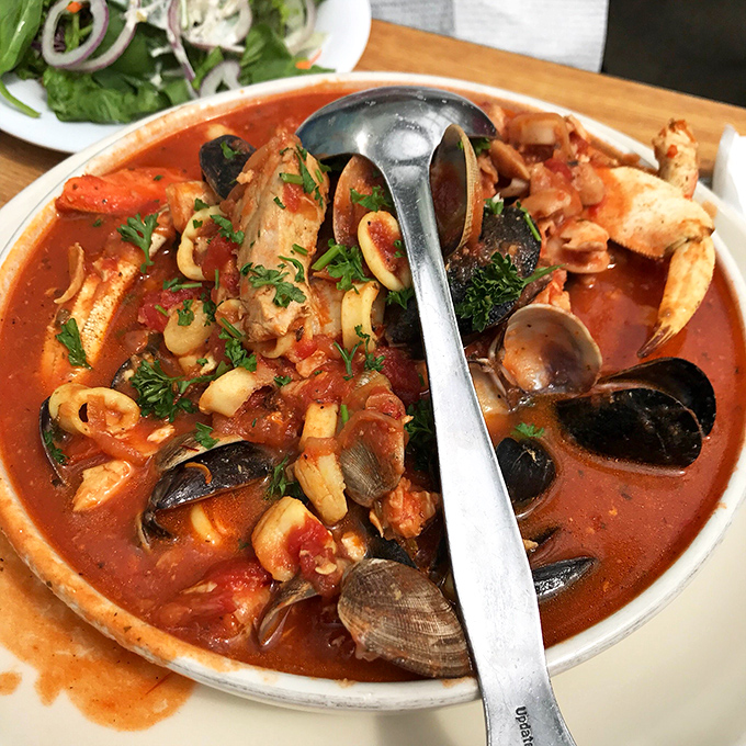 The legendary cioppino: a tomato-based seafood symphony in a bowl. This isn't soup—it's an edible maritime treasure hunt that requires both spoon and commitment.