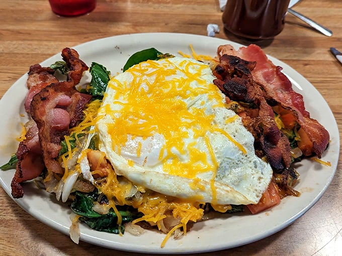 This Mixed Grill isn't just breakfast – it's a protein-packed landscape of morning delights topped with a sunny-side masterpiece and melted cheese.