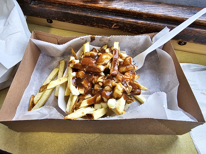 Poutine done right—crispy fries drowning happily under a blanket of gravy that cascades into every delicious nook and cranny.
