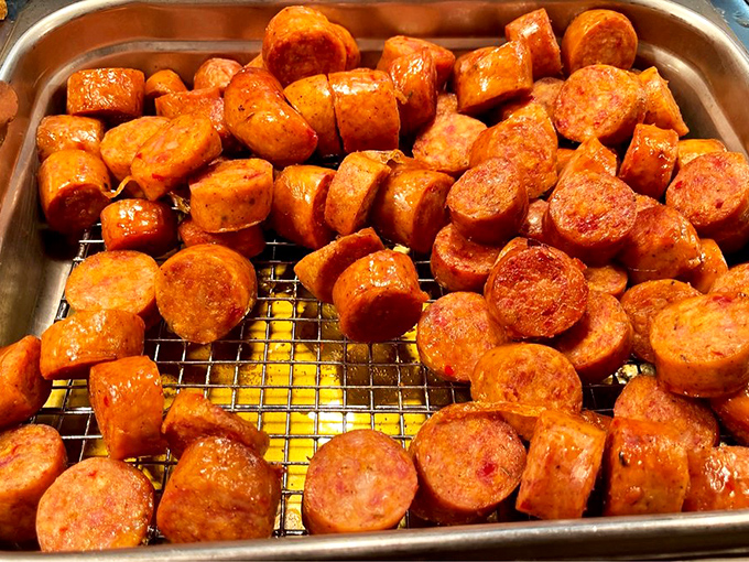 Sausage slices glistening with promise – each one a spicy, savory coin from the Southern food bank of happiness.