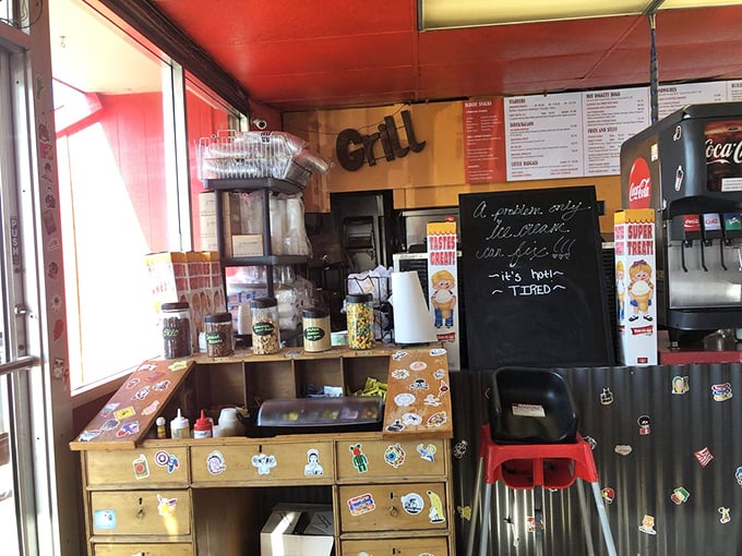 Behind this counter, burger artisans work their magic. The sticker-covered surfaces speak to years of loyal customers and evolving menu innovations.