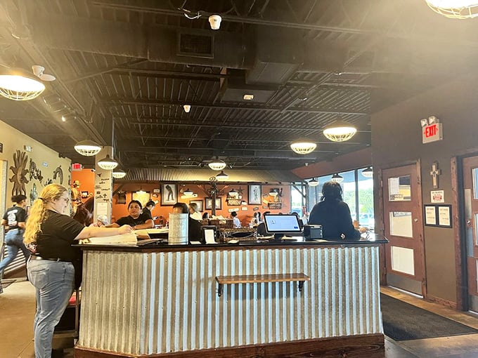 The corrugated metal counter says "rustic charm" while the busy staff says "we know you came for the French toast, and we're on it."