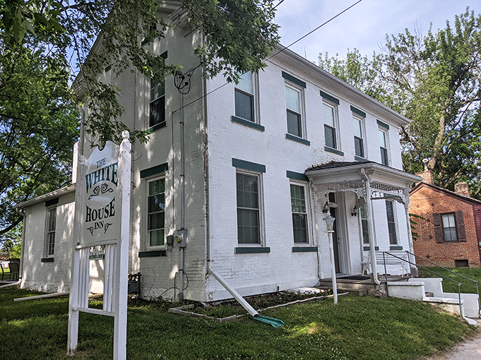 The White House Inn stands pristine against blue skies, offering modern comforts in historical packaging. It's like time travel with indoor plumbing—the best kind.
