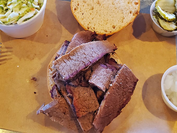 Brisket sliced so perfectly you could read a newspaper through it, displaying that telltale pink smoke ring that whispers, "I took my time."