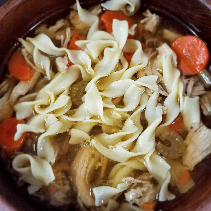 Classic chicken noodle soup that looks like it could cure anything from a cold to existential dread. Those wide egg noodles swimming in golden broth promise comfort.