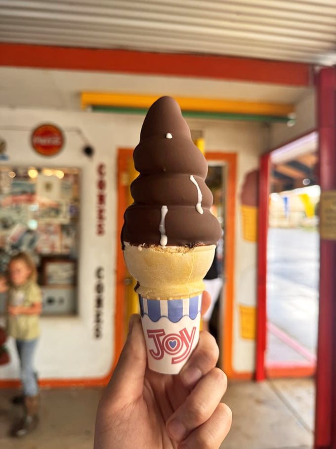 Ice cream architecture at its finest—a chocolate-dipped cone that demands to be photographed before the Arizona sun gets any ideas.