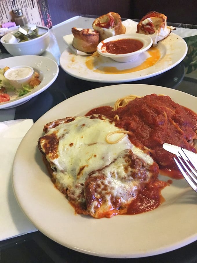 Eggplant parmesan and pasta playing the ultimate dynamic duo, like Batman and Robin if they were delicious and covered in cheese.