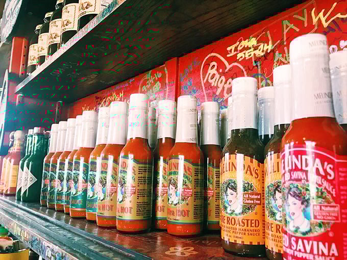 A hot sauce collection that would make a fire-eater weep with joy—each bottle promising to take your taste buds on a different adventure.