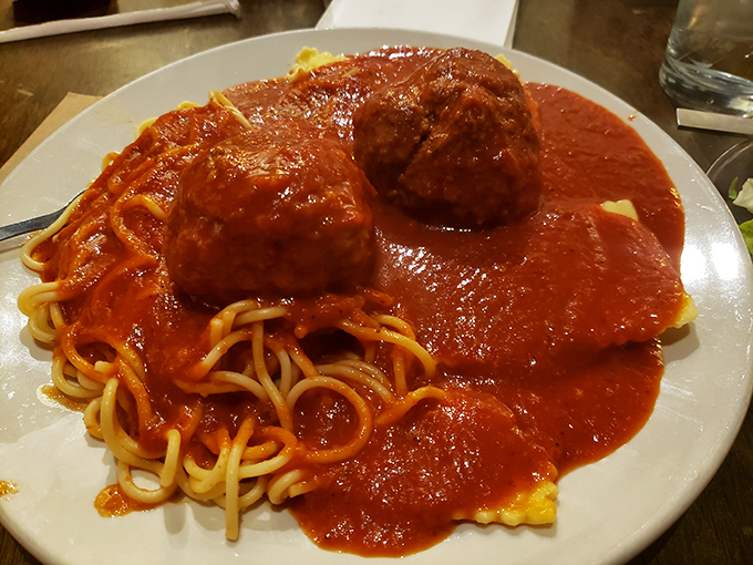 This isn't just spaghetti and meatballs—it's a masterclass in comfort. Those meatballs stand proud like monuments in a sea of perfect sauce.