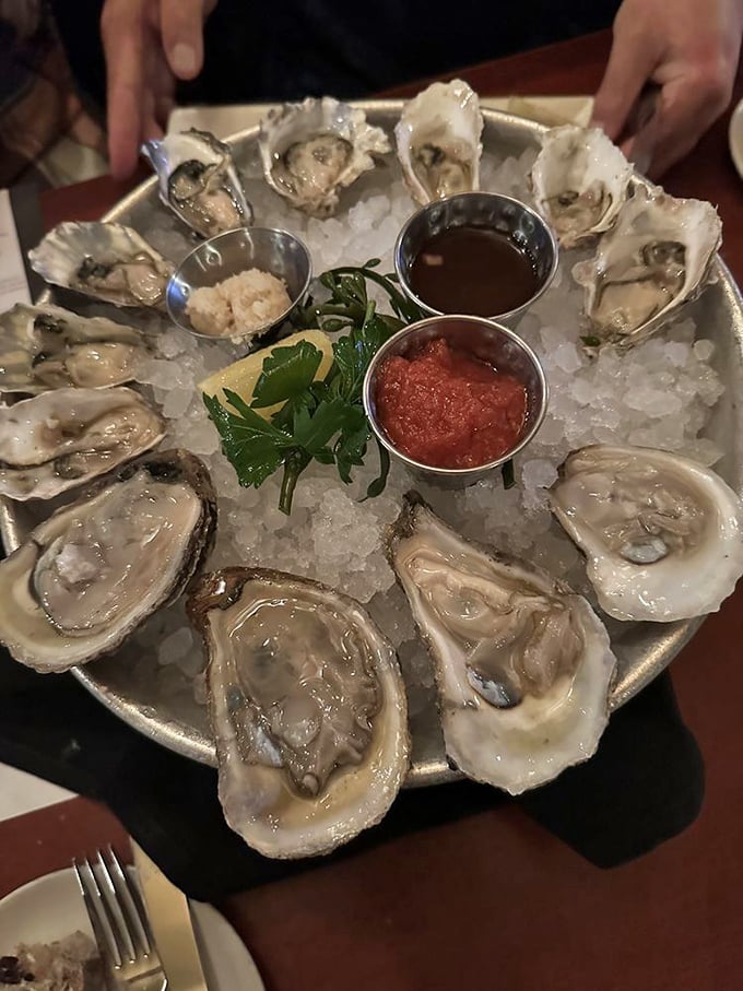 A platter of oysters on ice, arranged like jewels with three dipping sauces – nature's perfect appetizer awaits your verdict.