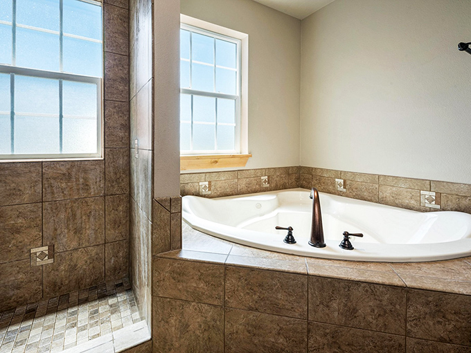 The royal bathroom combines luxury and practicality with its spacious soaking tub and walk-in shower—medieval comfort with decidedly modern plumbing.