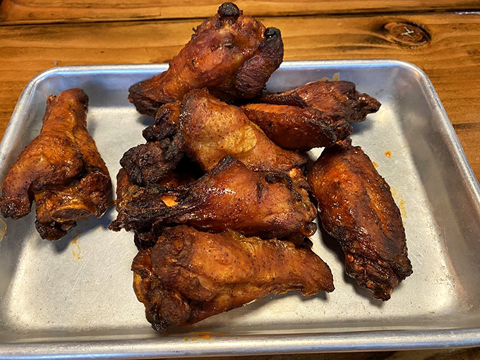 These wings have clearly been introduced to heat twice—once in the smoker and again in the fryer—resulting in a texture that's nothing short of chicken alchemy.