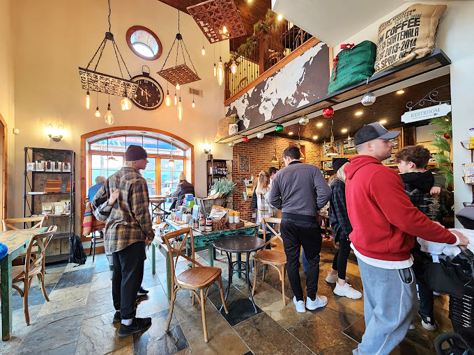 The morning coffee pilgrimage in full swing. High ceilings, pendant lights, and the buzz of caffeine-seekers create an atmosphere as rich as the espresso.