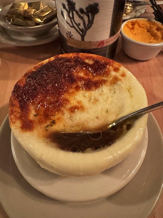 Beneath that bronzed cheese canopy lies the soul-warming magic of French onion soup—a bowl that turns strangers into evangelists.