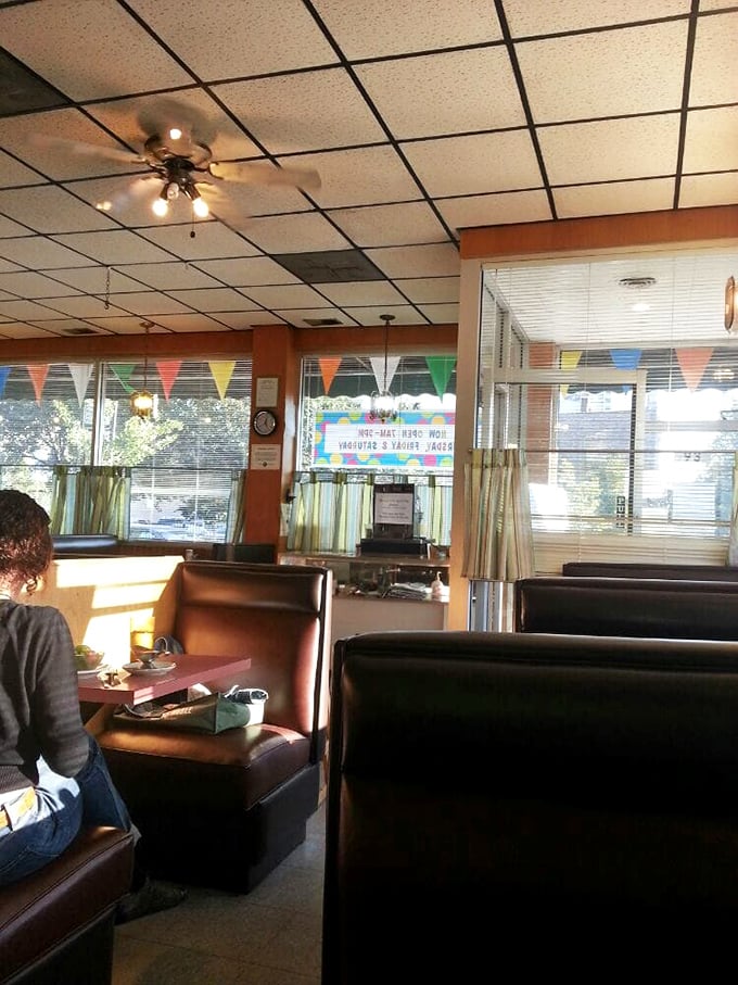 Those high-backed booths—the Switzerland of restaurant seating, offering neutral territory between privacy and people-watching.