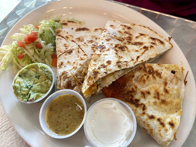 Quesadilla perfection: golden-brown exterior, melty interior, and those three perfect dipping sauces. It's a choose-your-own-adventure on a plate.