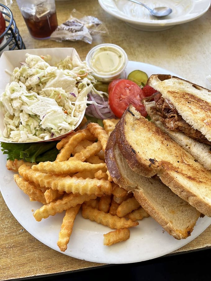 This isn't just a sandwich; it's architecture—a carefully constructed tower of flavor with coleslaw as the perfect counterpoint.