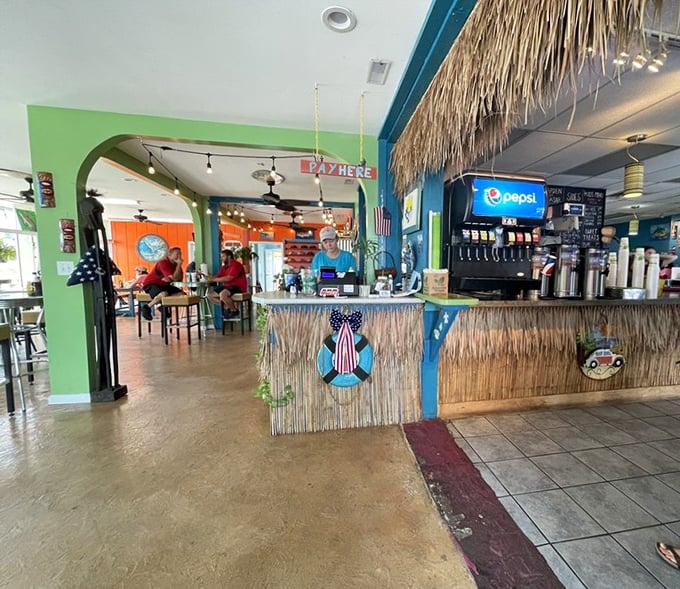 The tiki-inspired counter says "vacation" even if you're just on lunch break. That grass skirting? Pure coastal escapism.