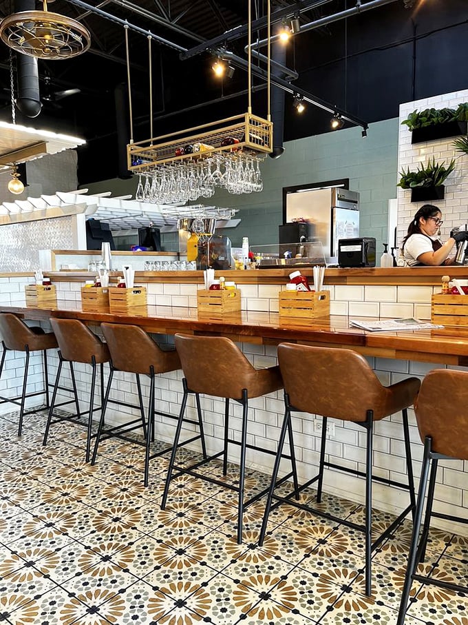 The bar area blends subway tile charm with pattern-play floors – proof that breakfast deserves as stylish a setting as dinner.