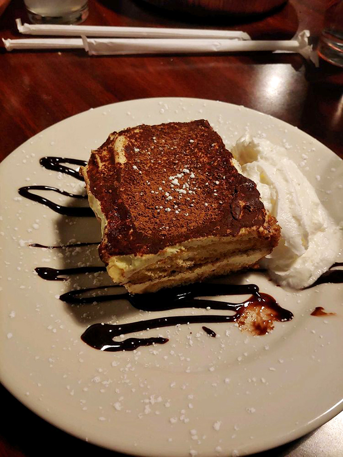 Tiramisu that doesn't skimp on the good stuff. The chocolate dusting on top is like a velvet blanket for your dessert dreams.