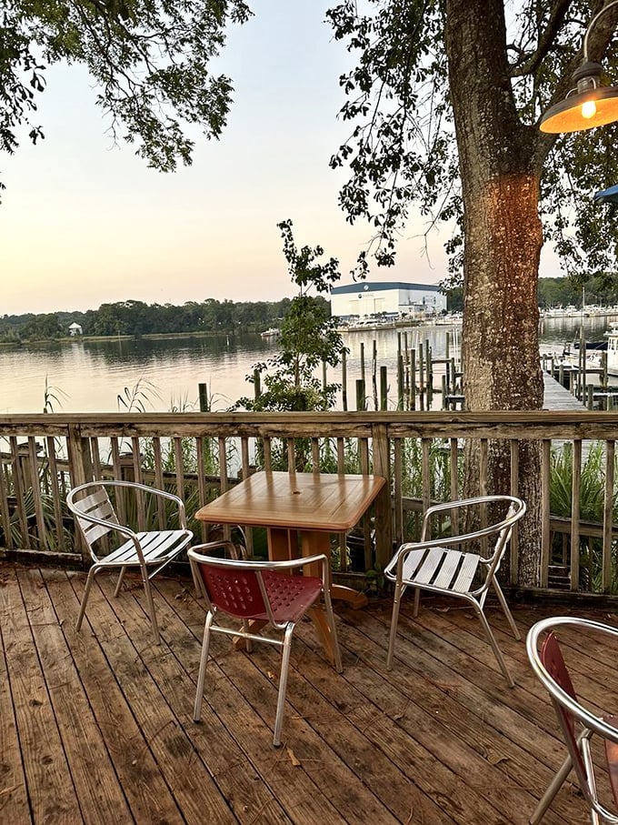 Sunset transforms Boggy Bayou into a shimmering canvas of gold and pink—nature's dinner theater for lucky patrons seated on the deck.