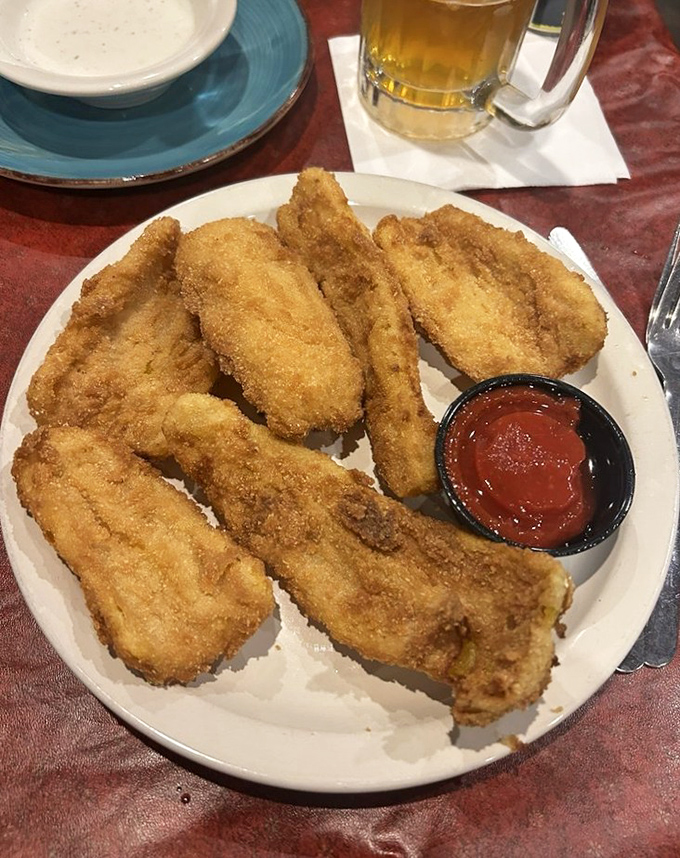 Fried chicken tenders with the golden ratio of crunch-to-tenderness. That dipping sauce isn't optional—it's essential to the experience.