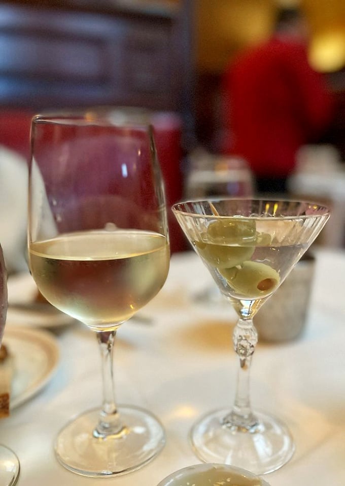 The perfect pairing: a chilled white wine and a martini with olives—liquid civilization in its highest form.