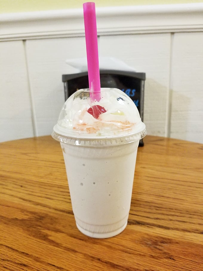 This milkshake brings all the joy to the yard—creamy, cold, and crowned with a cherry that's just showing off.