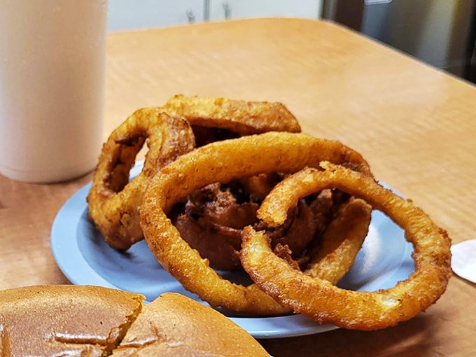 Onion rings with the structural integrity of Olympic gold medals—crispy, substantial, and demanding to be dunked in ketchup or eaten straight-up in all their golden glory.