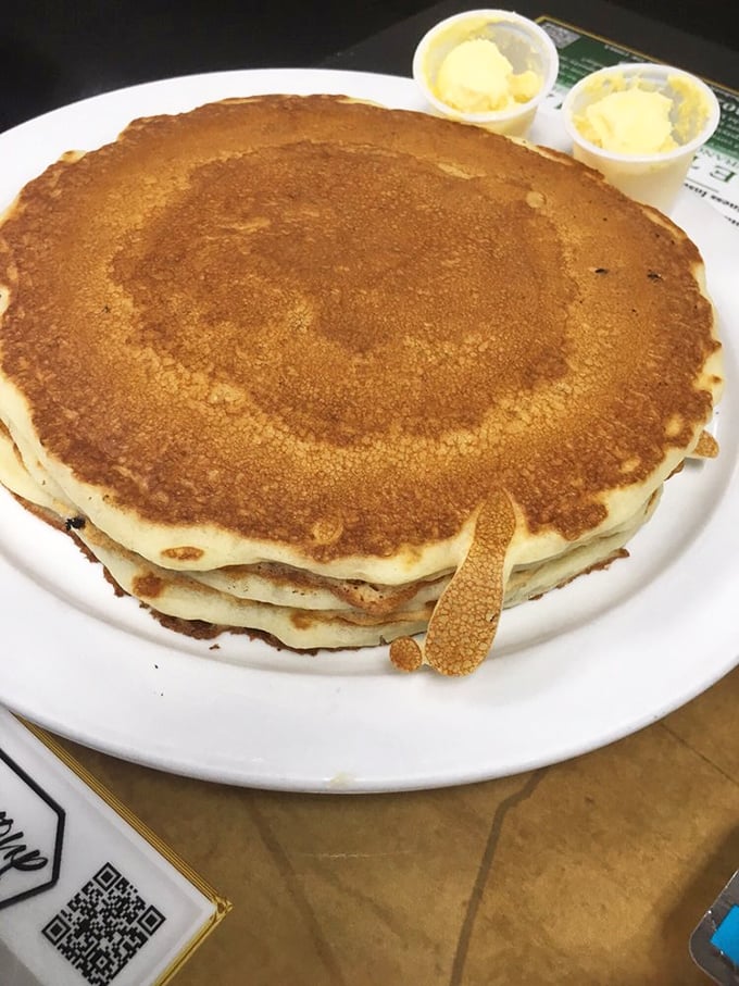 Pancakes stacked higher than weekend expectations, with butter melting languidly down the sides. Maple syrup application pending.