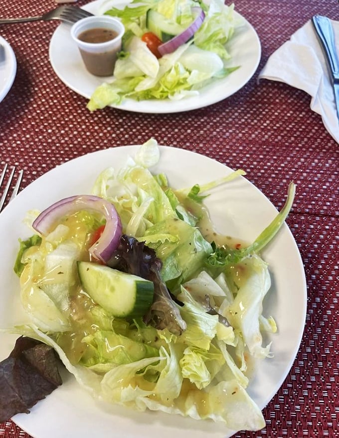 The side salad: pasta's modest companion. Fresh, crisp, and dressed just right—the perfect counterpoint to carb-laden bliss.