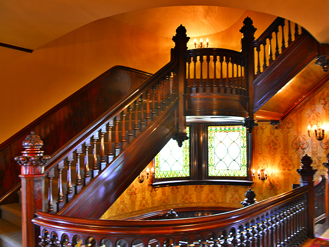 This staircase wasn't just built—it was composed, like a symphony in wood. The warm glow of the wall sconces creates an ambiance that no Instagram filter could improve.
