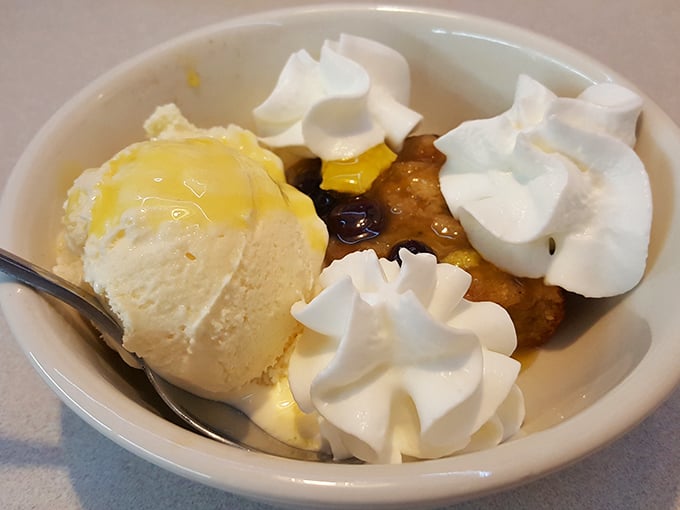 Dessert that understands the importance of excess. Ice cream, whipped cream, and what appears to be cobbler creating a sweet triumvirate of indulgence.