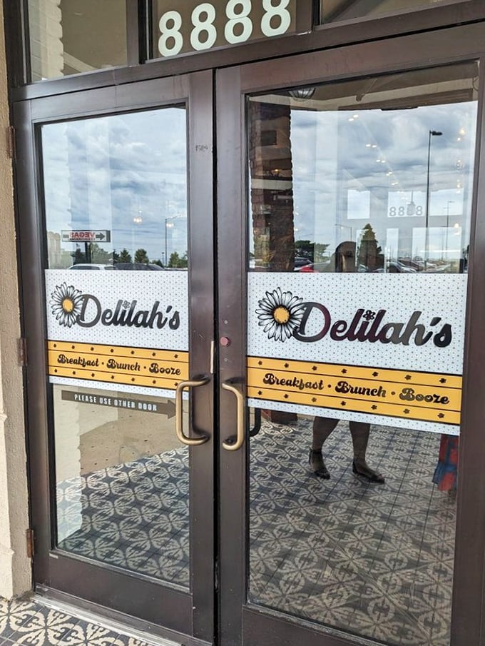 The entrance to Delilah's promises "Breakfast • Brunch • Booze" – the holy trinity of weekend morning salvation for grown-ups.