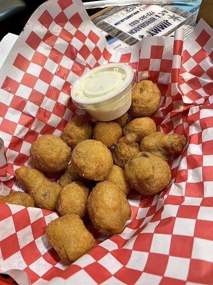 Mushroom poppers nestled in their red checkered cradle. These golden orbs of joy aren't just appetizers—they're little portals to happiness.