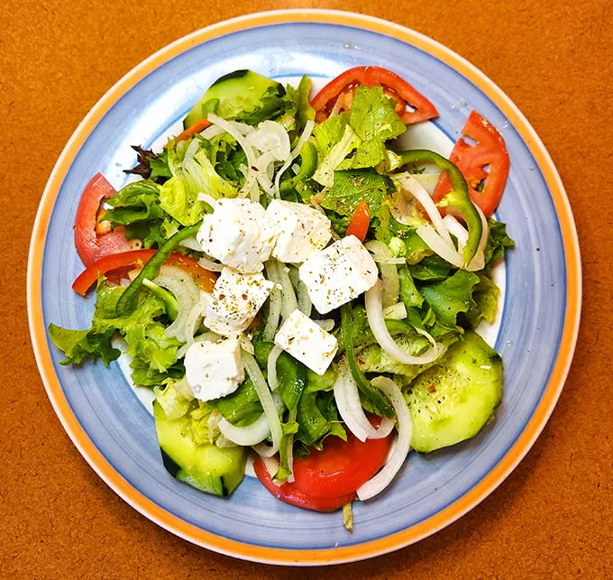 Stella's Greek salad brings Mediterranean sunshine to the Windy City. Those feta cubes aren't just cheese—they're little blocks of vacation.