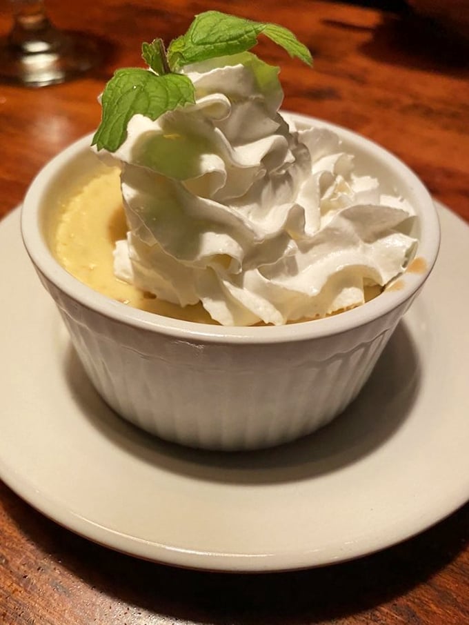 This isn't just Key Lime Pie—it's sunshine in a ramekin topped with clouds of whipped cream and a mint leaf that's not just garnish, but permission to indulge.