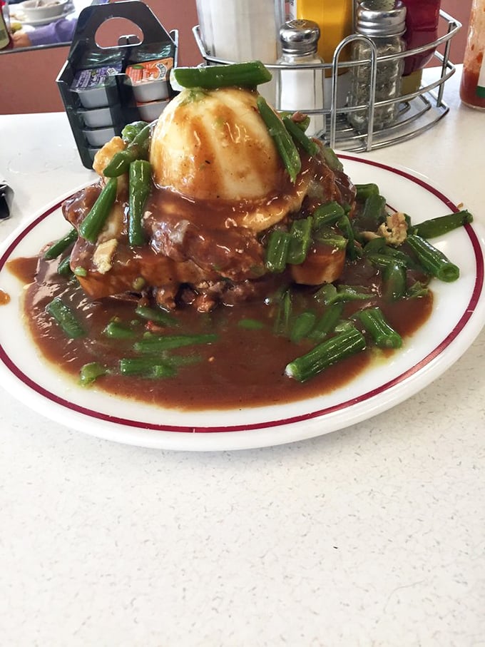 The legendary "Meatloaf Mountain" arrives like a savory volcano erupting with gravy and green beans—a dish that demands both a fork and a nap afterward.