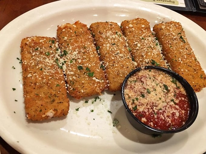 Golden-brown mozzarella sticks: the universal language of appetizer joy. Crispy outside, molten inside, with marinara for essential dipping rituals.