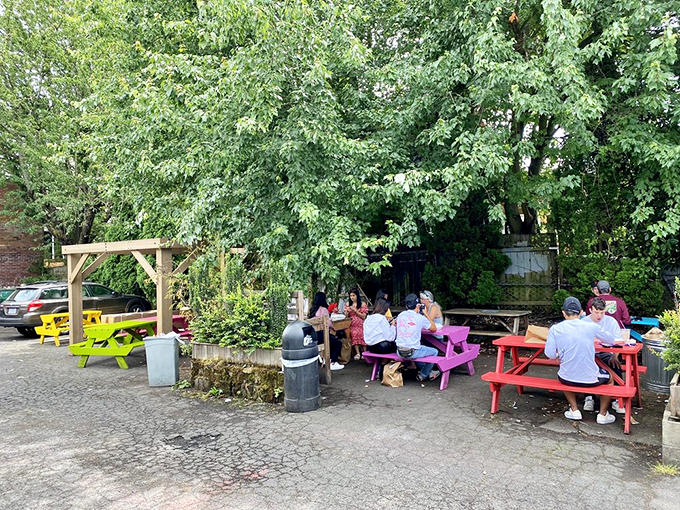 Colorful picnic tables under leafy trees create Portland's perfect outdoor dining spot—where waffle-lovers gather like a delicious support group.