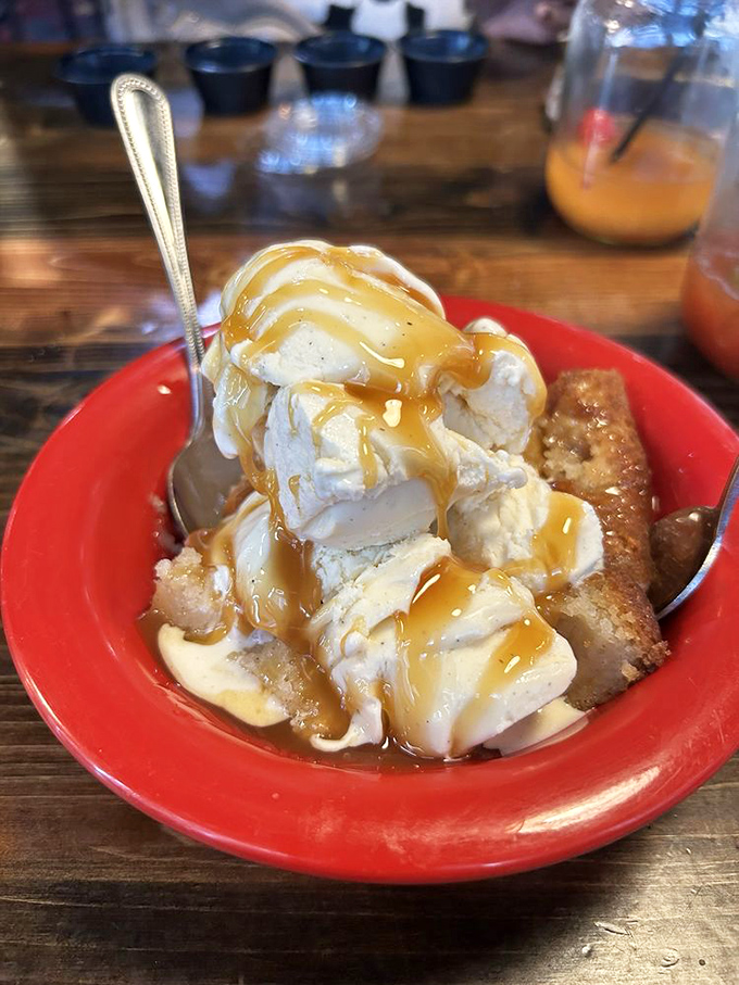 This isn't just dessert—it's warm peach cobbler supporting a melting ice cream archipelago in a sea of caramel, demanding both your spoon and your undivided attention.