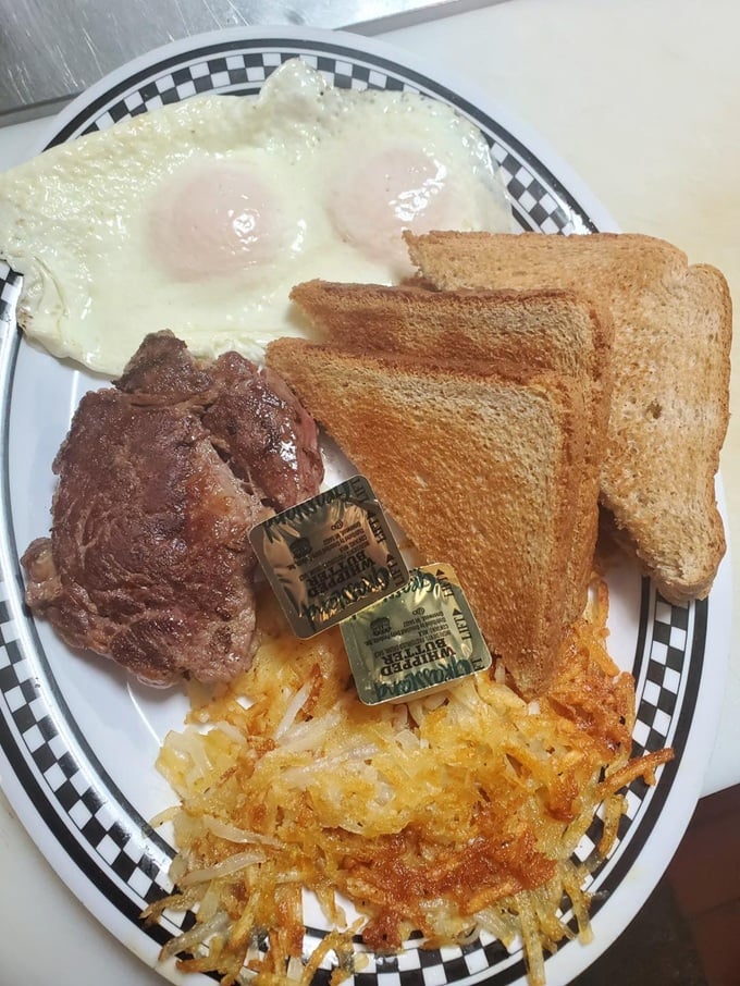 The breakfast of champions: two sunny eggs, crispy hash browns, and steak to fuel your Arkansas road trip adventures.
