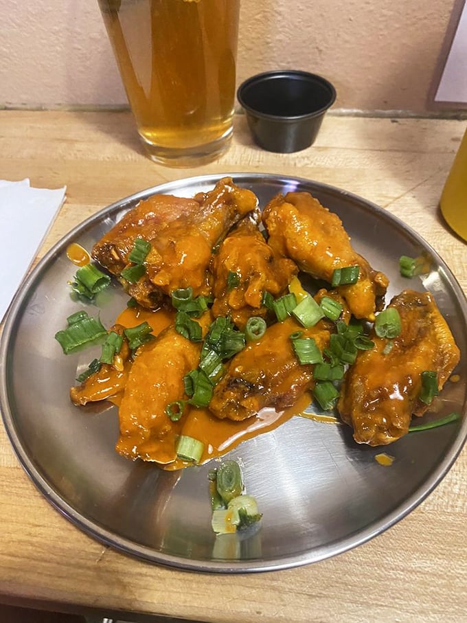 Wing wizardry in action. These Buffalo beauties garnished with green onions bring the heat while keeping all their juicy promises.