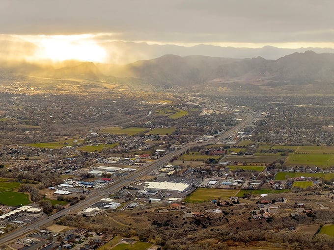 Heaven's spotlight shines on Cañon City in this aerial view, showcasing how mountains embrace this affordable retirement haven.