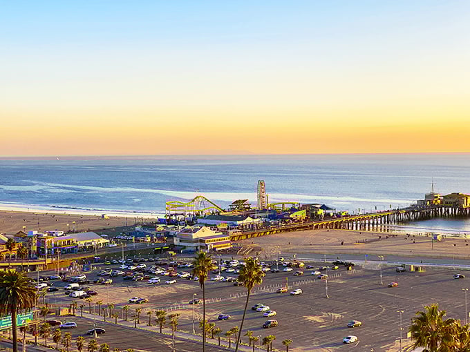 From above, the Santa Monica Pier reveals its true magic—a colorful playground where the edge of America meets endless ocean, bathed in that golden California sunset glow.