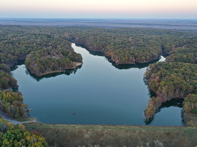 From above, the lake reveals its true personality – a blue oasis cradled by forest, shaped like nature's own Rorschach test.