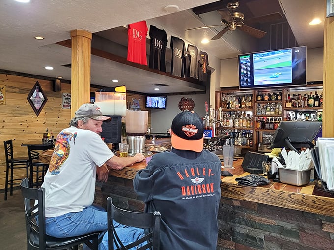 The bar where strangers become regulars and regulars become friends. Derby Grille merchandise hanging above tells you this isn't just a meal—it's membership.